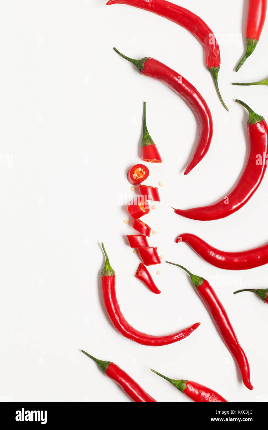 Sliced red chili pepper arranged on a plain background Stock Photo - Alamy