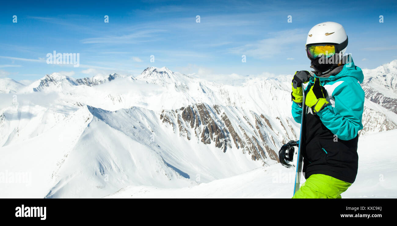 Portrait of snowboarder woman on background beautiful landscape of ...