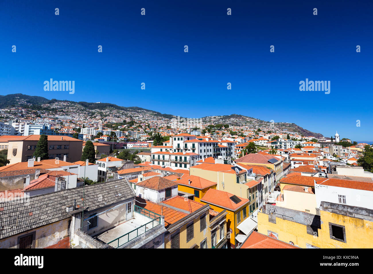 An aerial view of buildings and the mountains above Funchal in Madeira ...