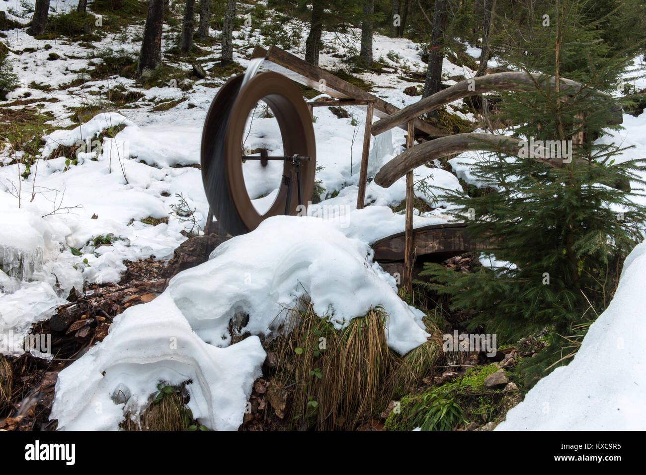 Functional small water mill wheel in the forest at winter Stock Photo ...