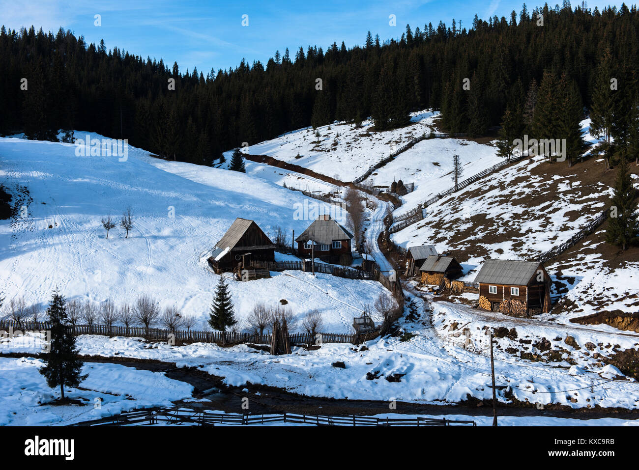 Traditional homestead with wooden houses at winter in Transylvania ...