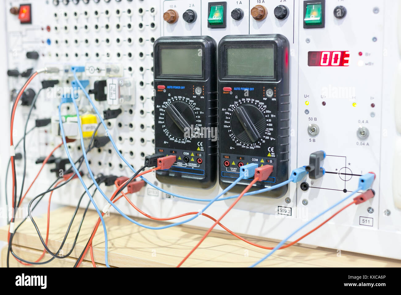 technology, electicity, factory concept. there are two multimeters that ...