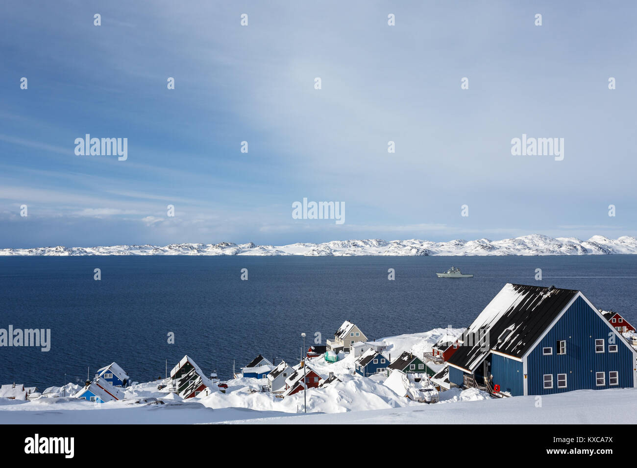 Covered in snow inuit houses at the fjord with drifting ship, Nuuk ...