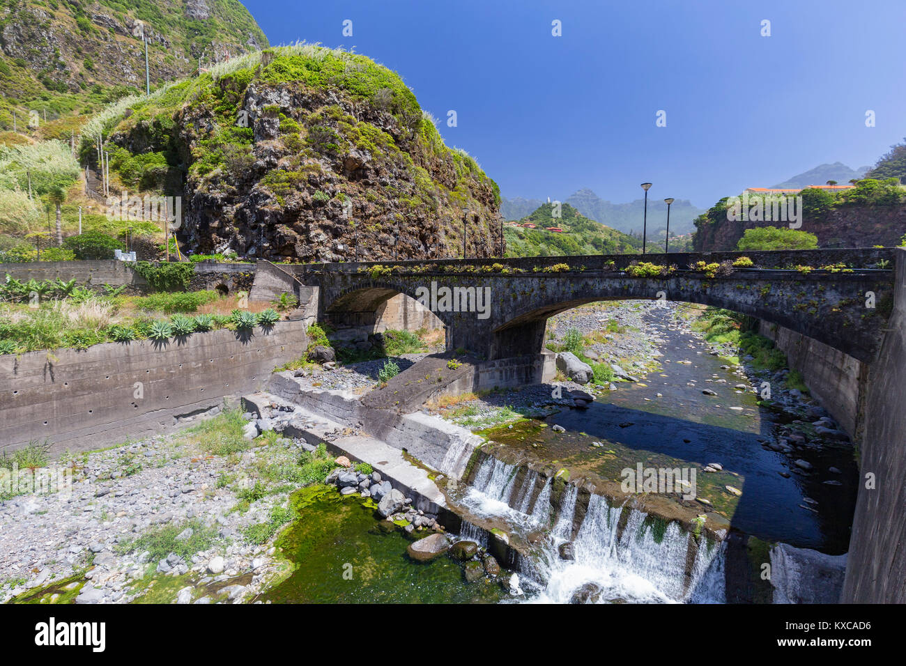 An old bridge crosses a river in the small village of Sao Vicente in ...