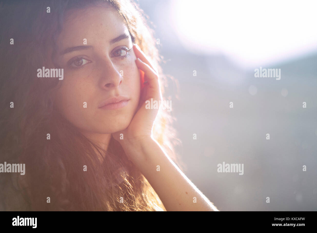 Portrait of young woman at a window Stock Photo - Alamy
