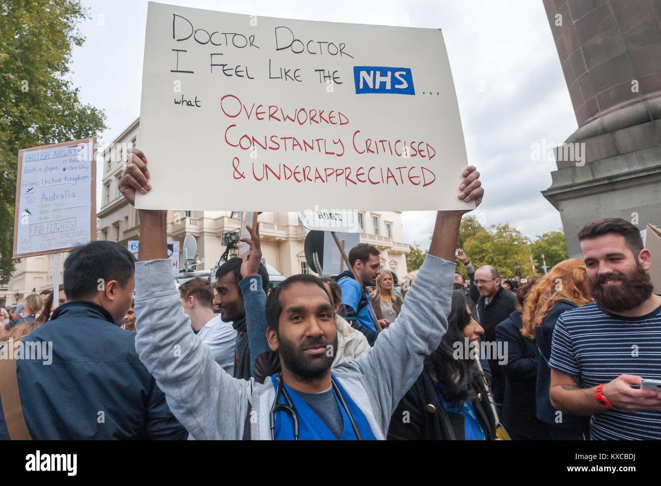 A doctor at the Junior doctors protest rally against new contract holds ...