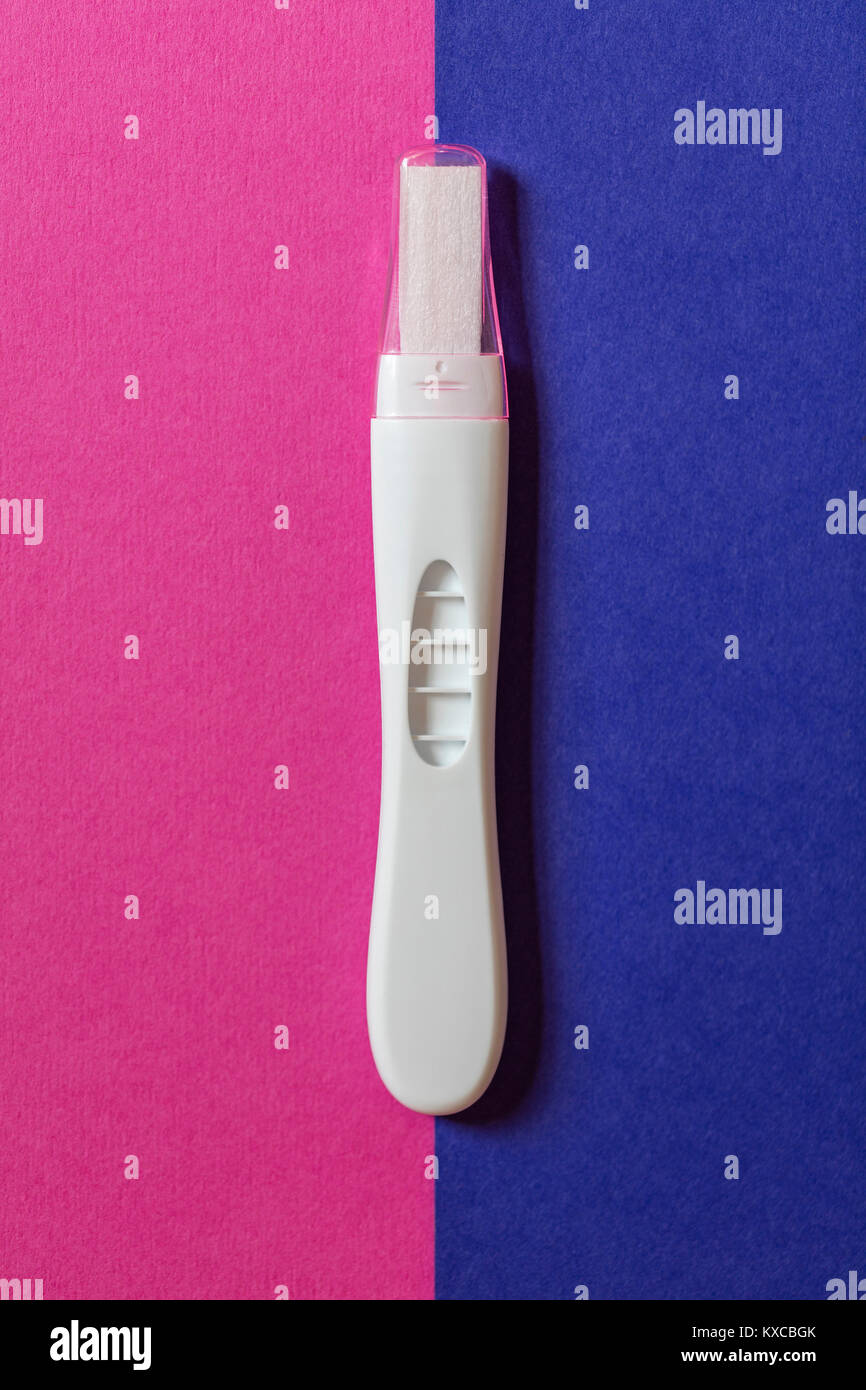 Pregnancy test on a blue and pink background Stock Photo - Alamy