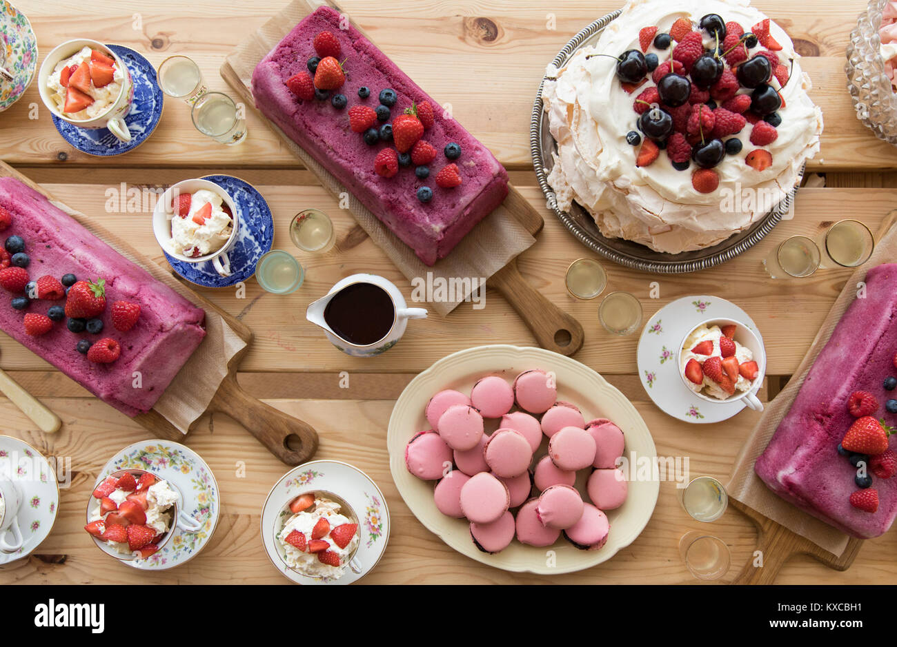 Overhead view of desert table with homemade pavlova summer pudding and ...