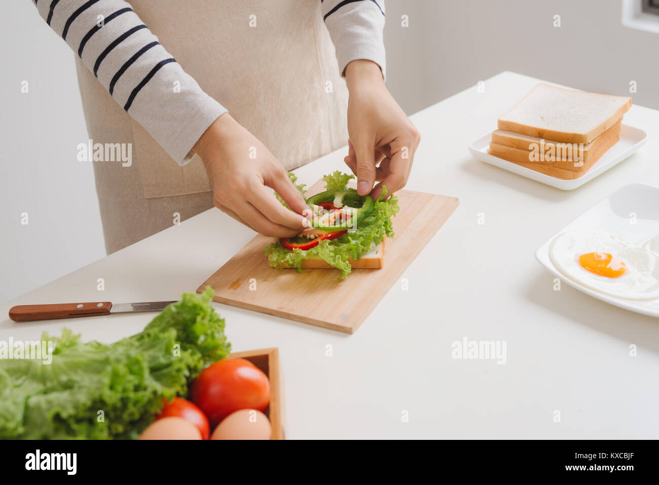 Preparing and eating breakfast at home in morning Stock Photo - Alamy