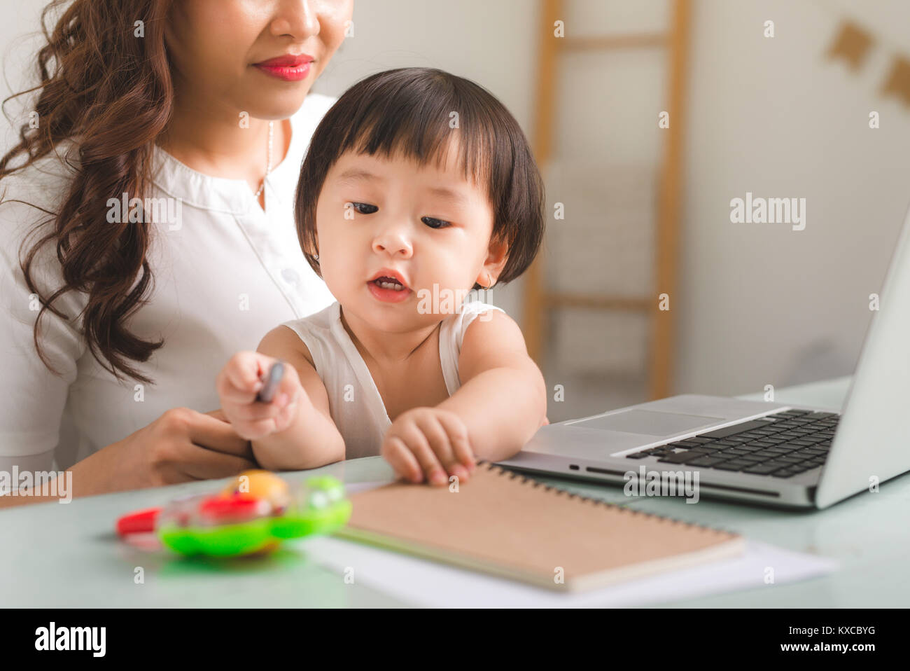 Mother and daughter are learning to write Stock Photo - Alamy