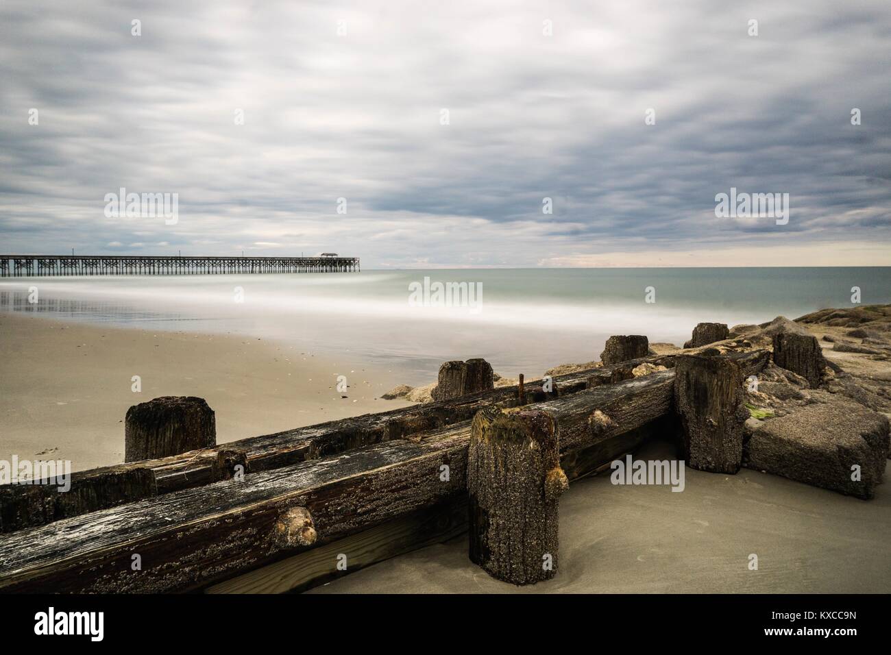 Pawleys Island beach with pier and storm groin Stock Photo - Alamy