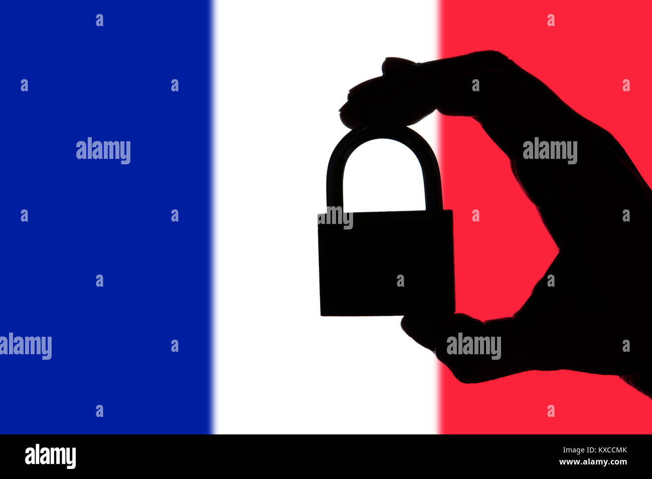 France security. Silhouette of hand holding a padlock over national ...