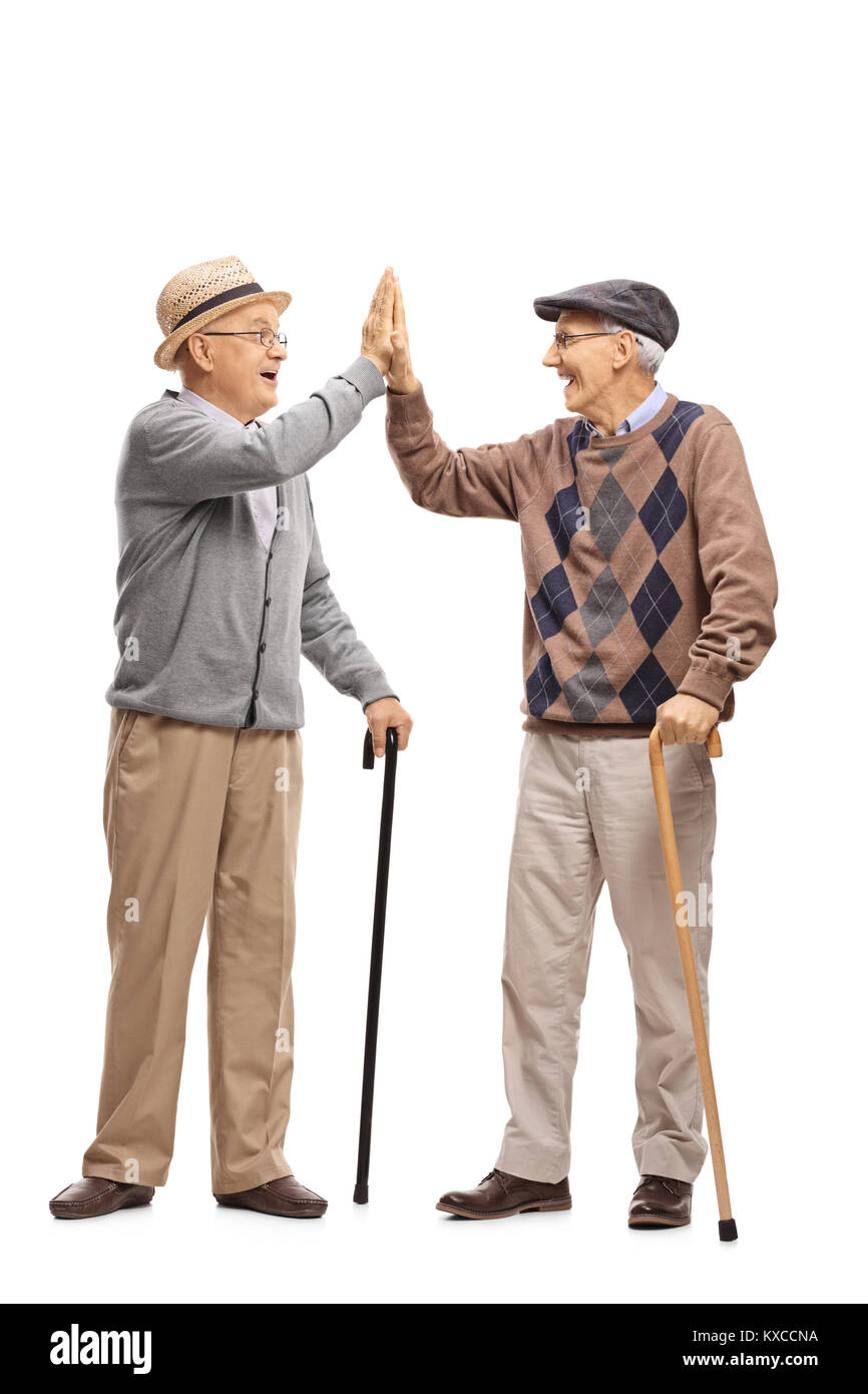 Full length profile shot of two elderly men high-fiving each other ...