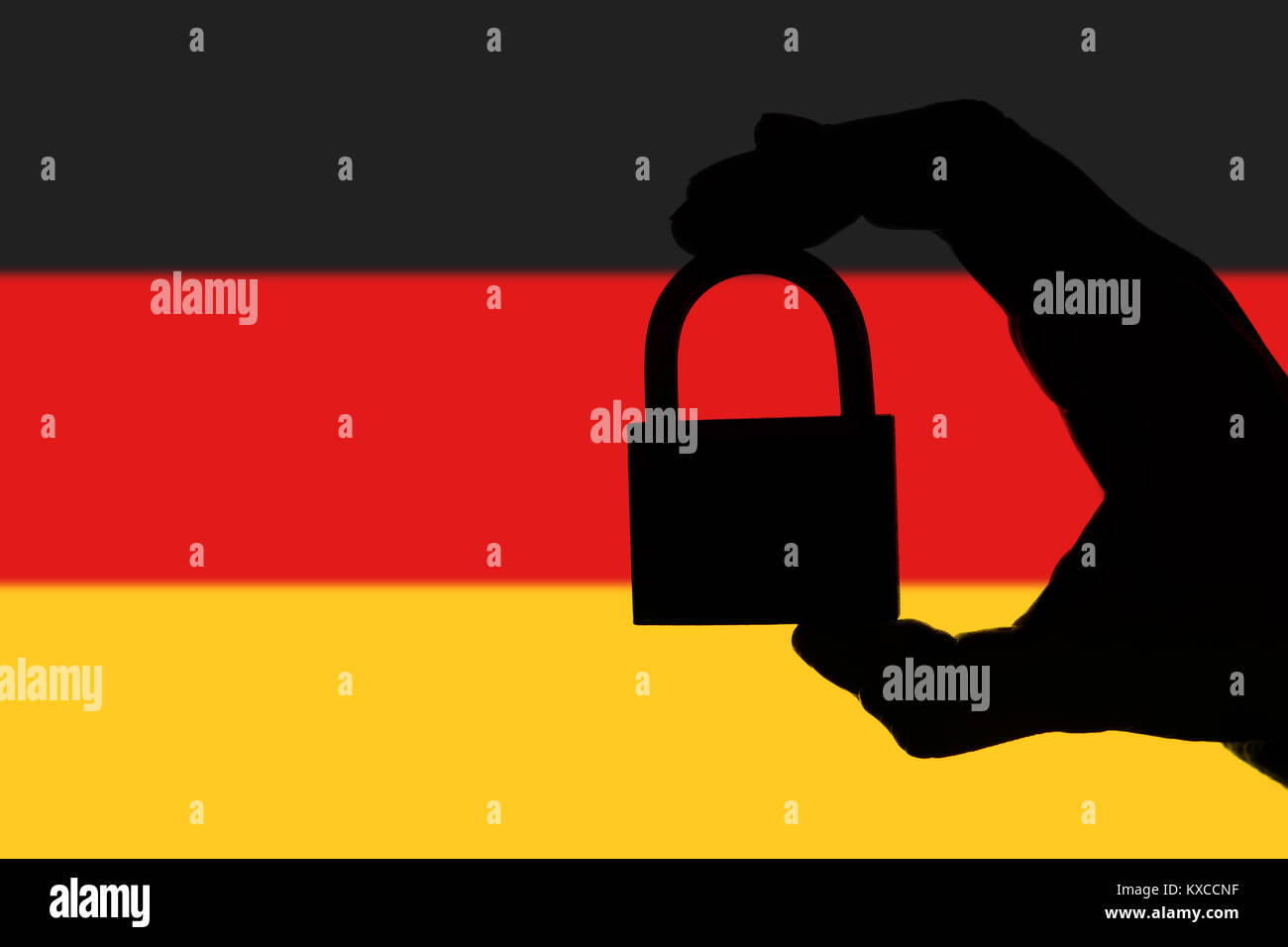 Germany security. Silhouette of hand holding a padlock over national ...