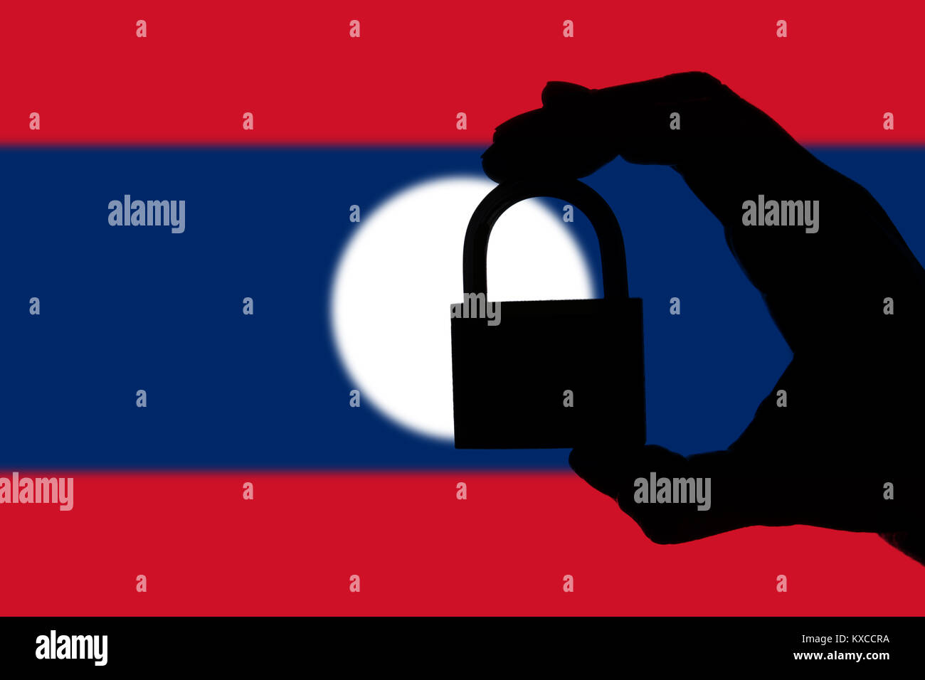 Laos security. Silhouette of hand holding a padlock over national flag ...