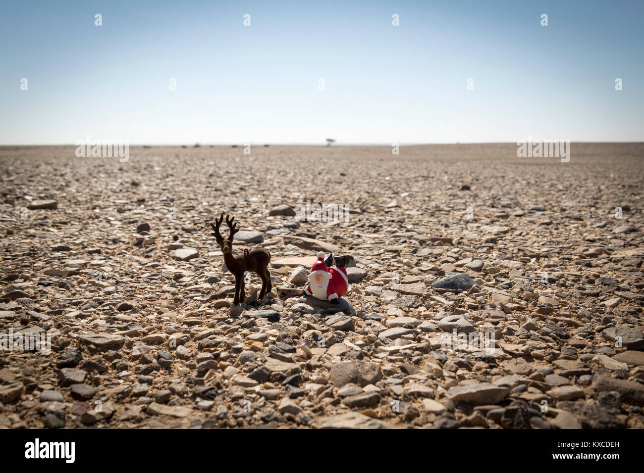 Santa Claus in the desert of rock (erg)with one of his deer enjoying ...