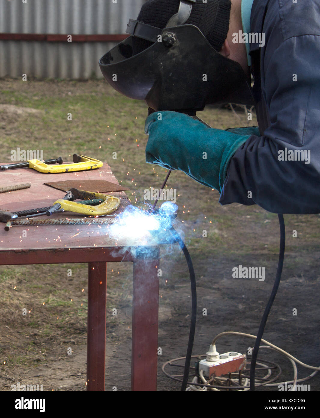 Welder weld metal constructions outdoors. Sincere photo Stock Photo - Alamy