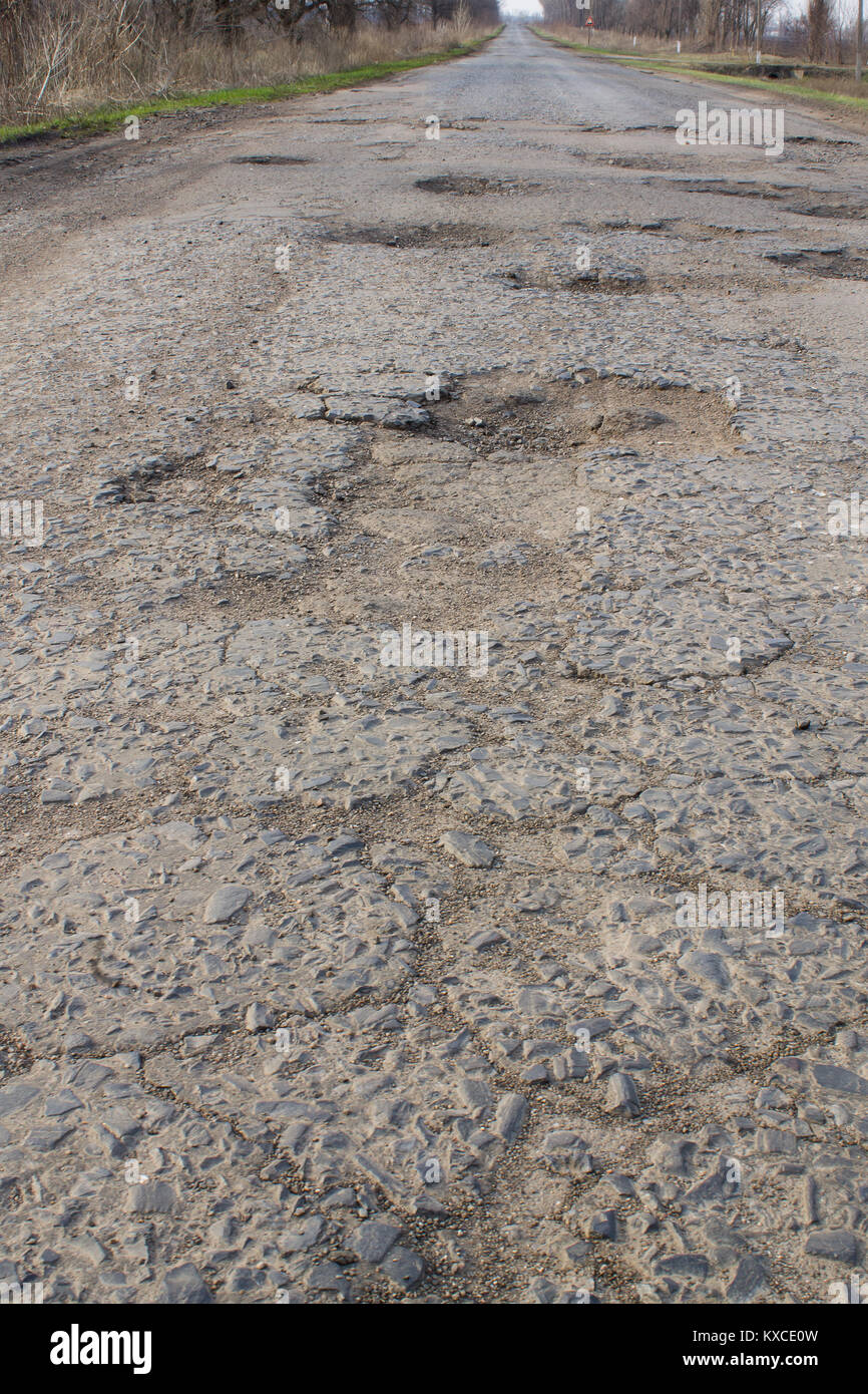 asphalt bad broken road with pits and potholes Stock Photo - Alamy