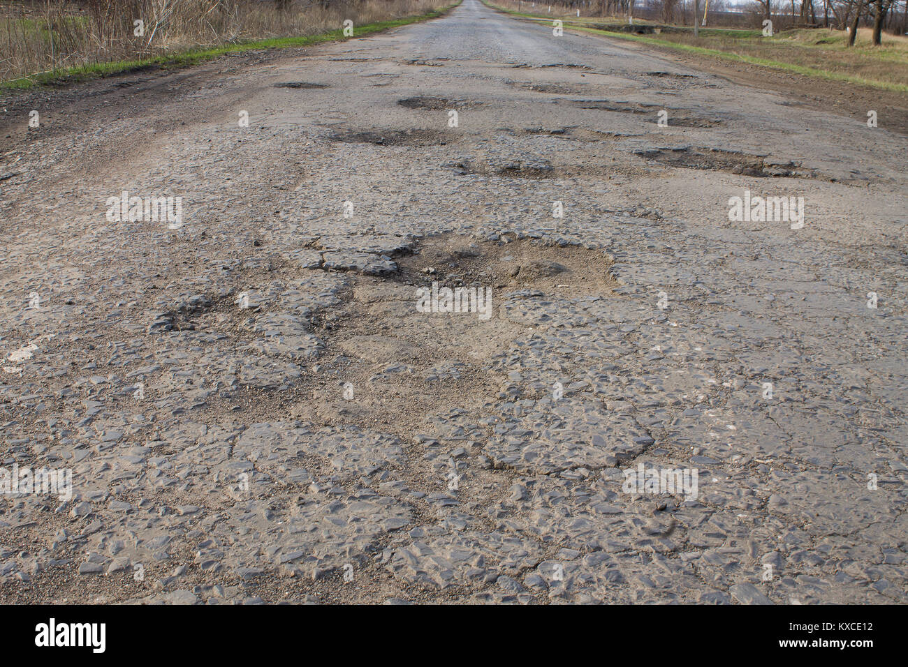 asphalt bad broken road with holes, cracks and potholes Stock Photo - Alamy