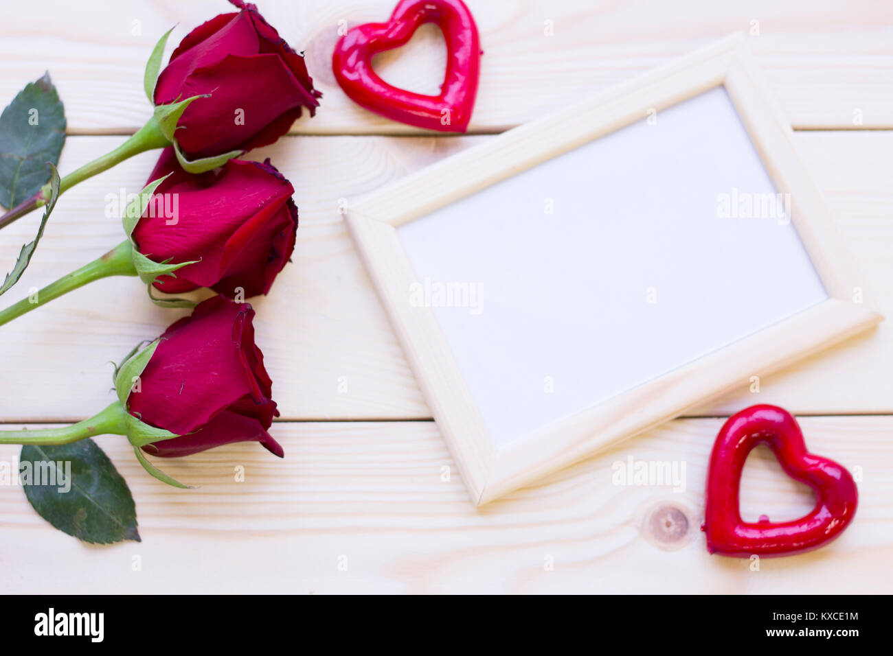Red roses and photo frame Stock Photo - Alamy
