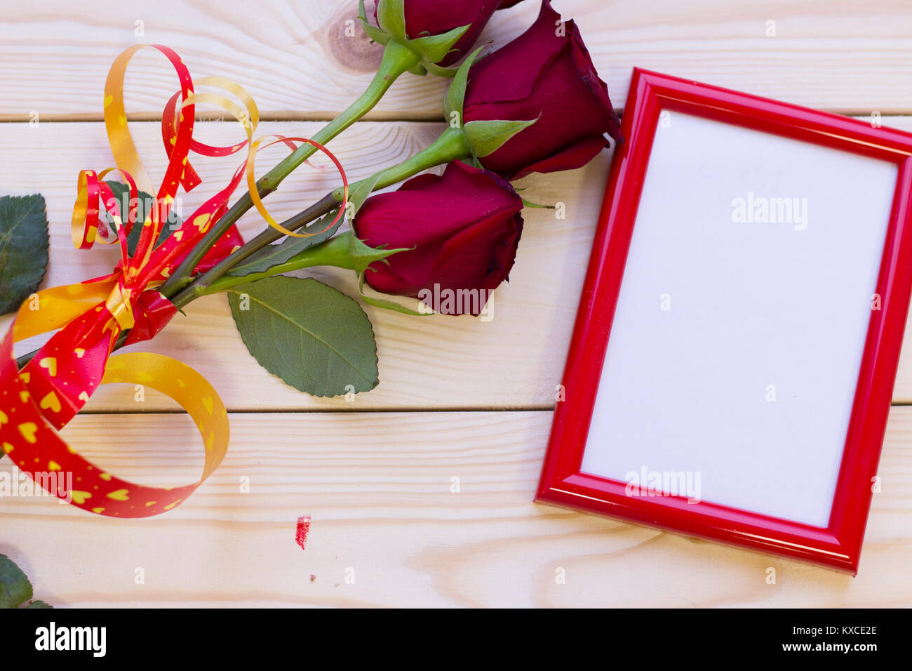 Red roses and photo frame Stock Photo - Alamy