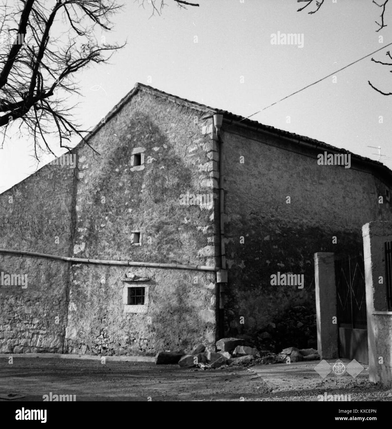 A historical photograph of the rear facade of a rural house in Veliki ...