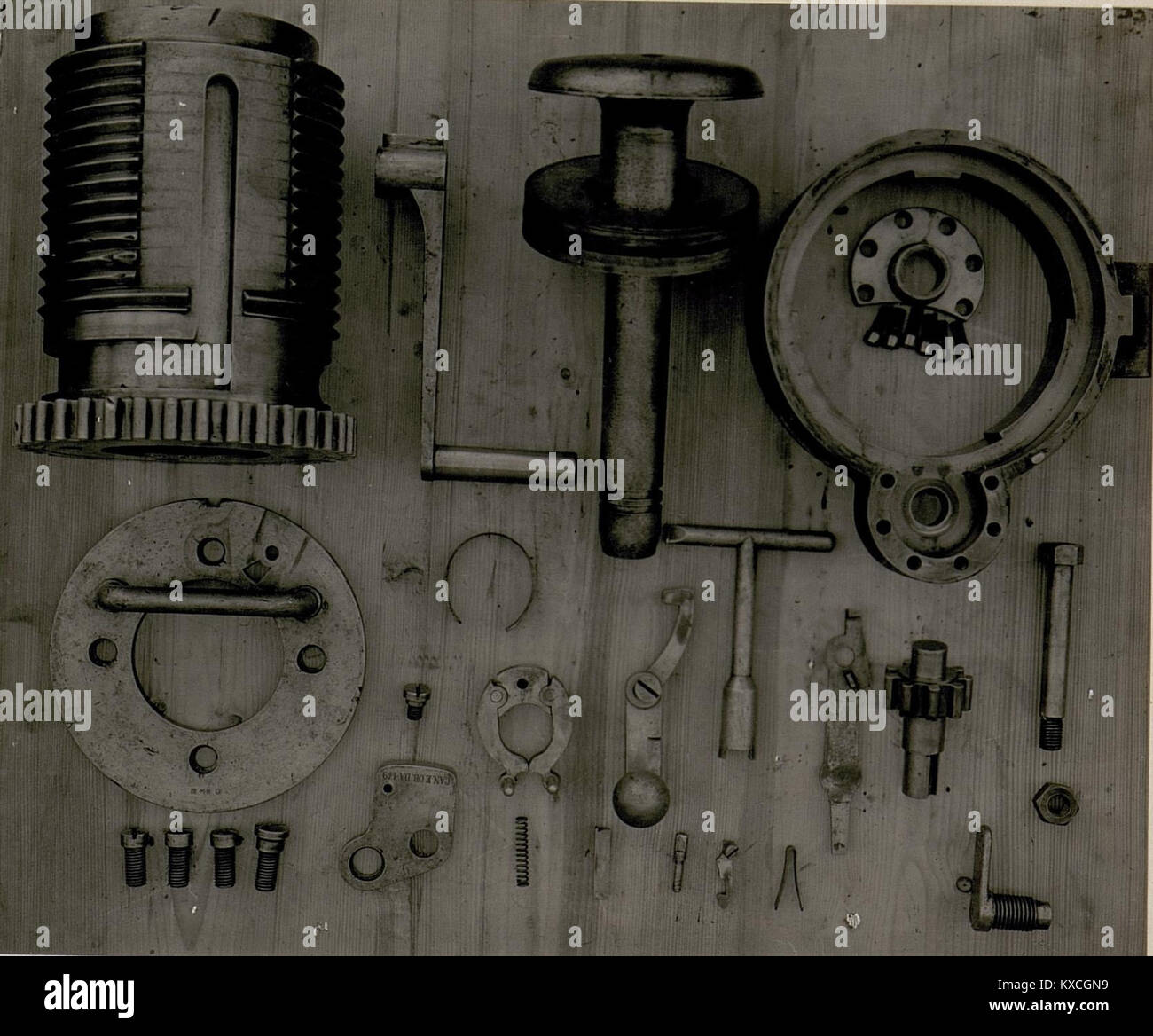 A technical photograph showing the disassembled breech mechanism of a ...
