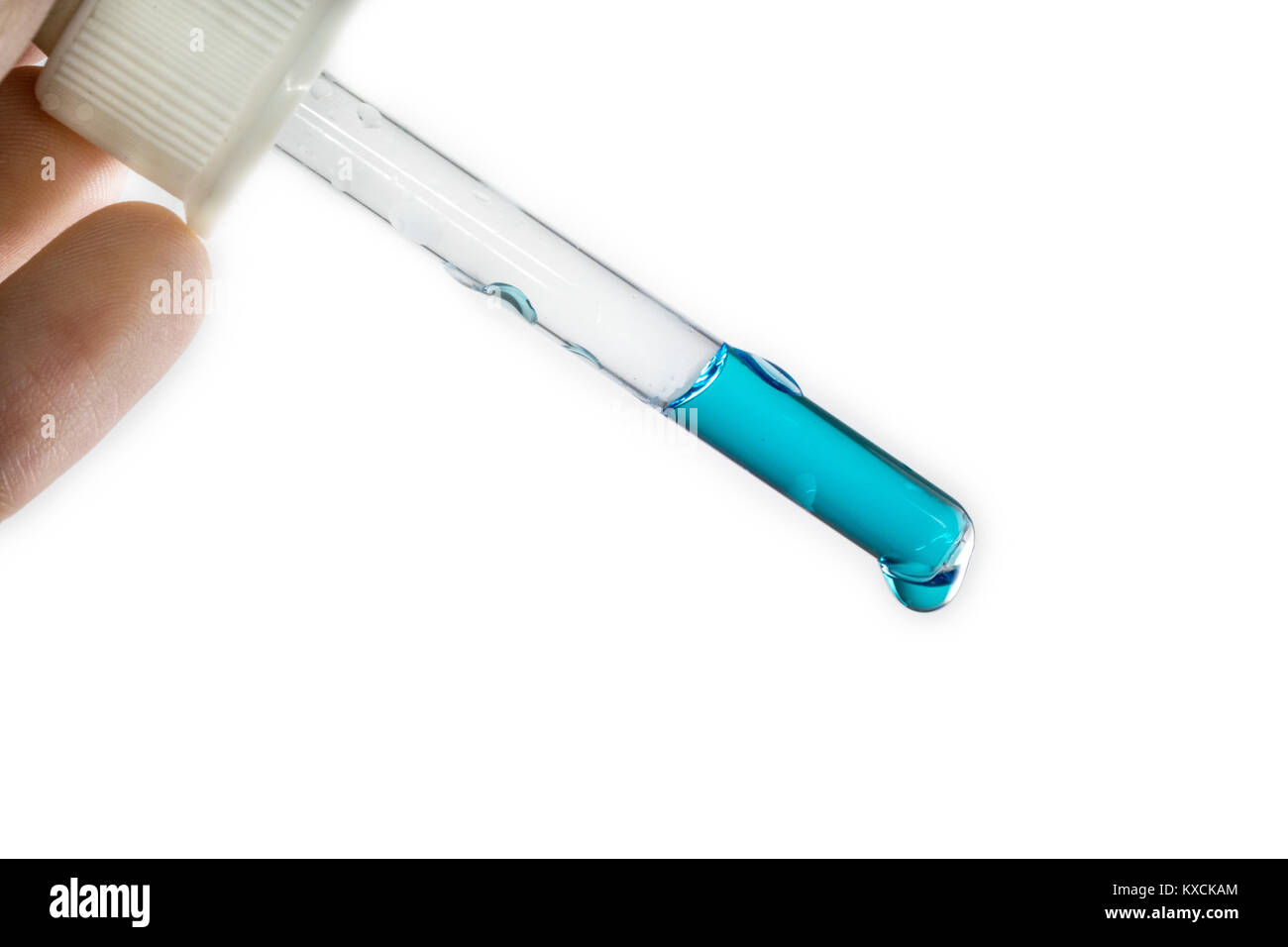 Pipette with blue liquid substance on a white background, closeup macro ...