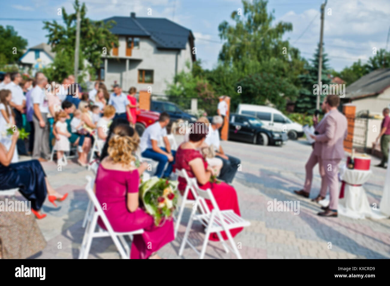 Guests sitting and waiting for wedding couple to arrive for the outdoor ...
