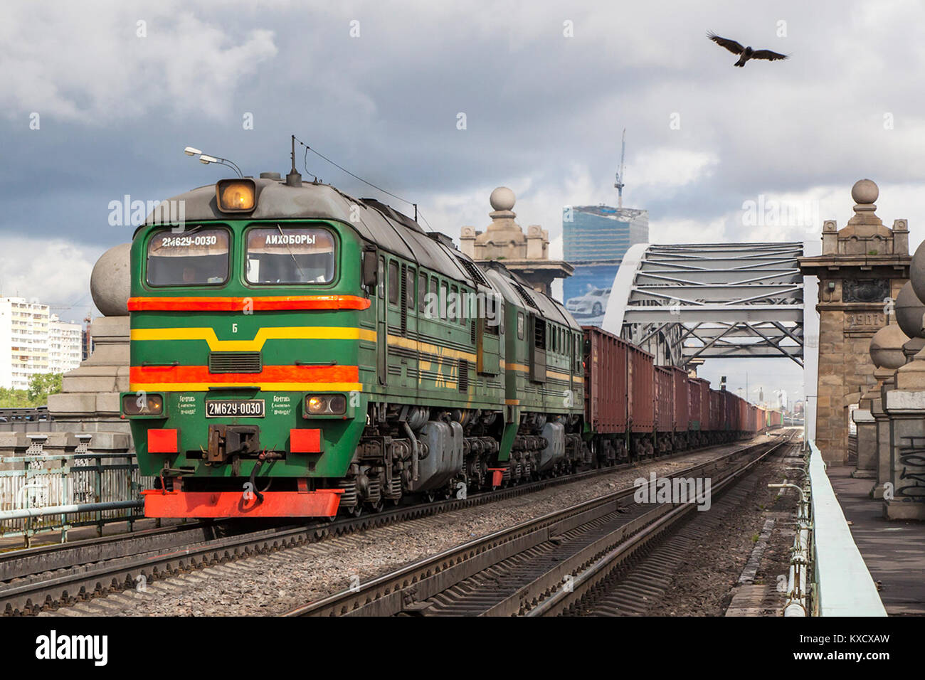 The image shows diesel locomotive model 2M62U-0030 pulling a freight ...