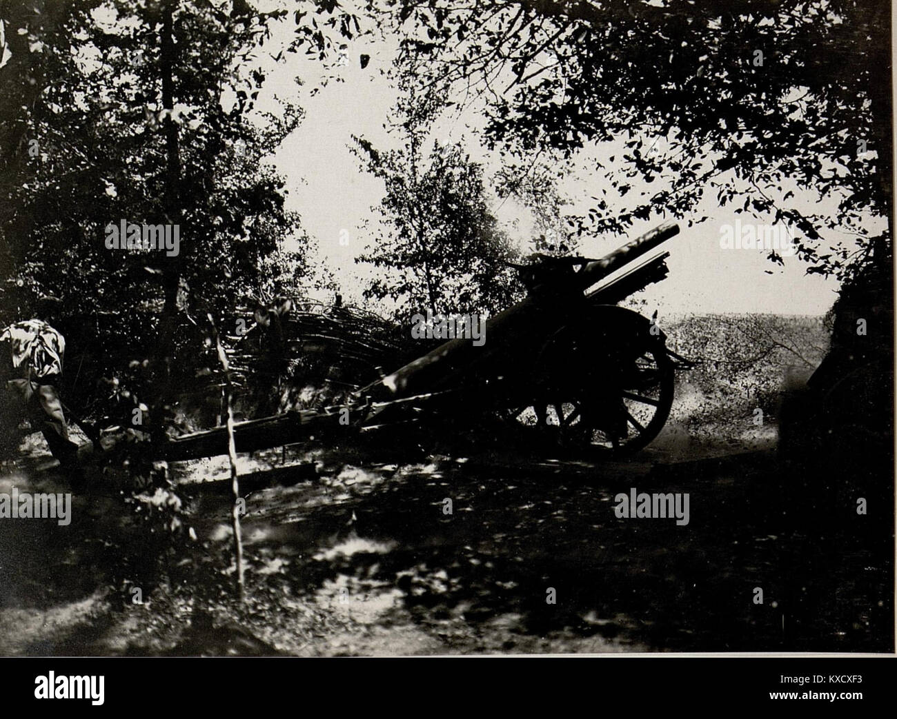 A historical image showing a 10.4 cm artillery gun being fired ...