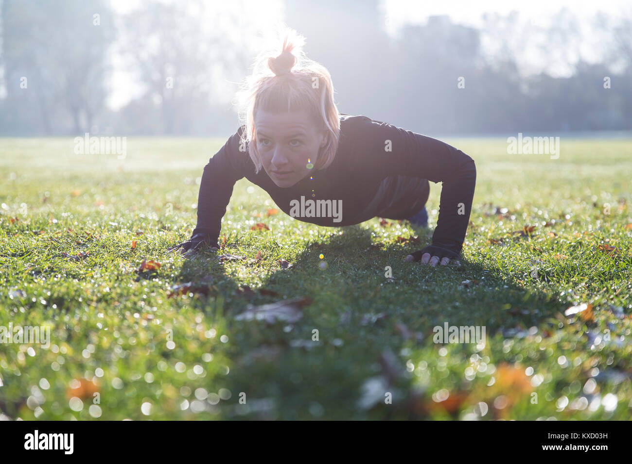 Woman doing push up on grass hi-res stock photography and images - Alamy