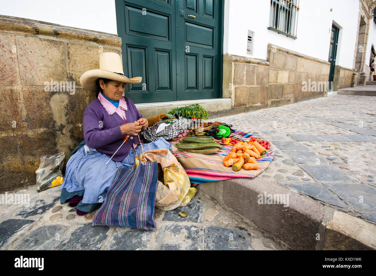 Street Vendor in Local Traditional Dress and Hat knitting and selling ...