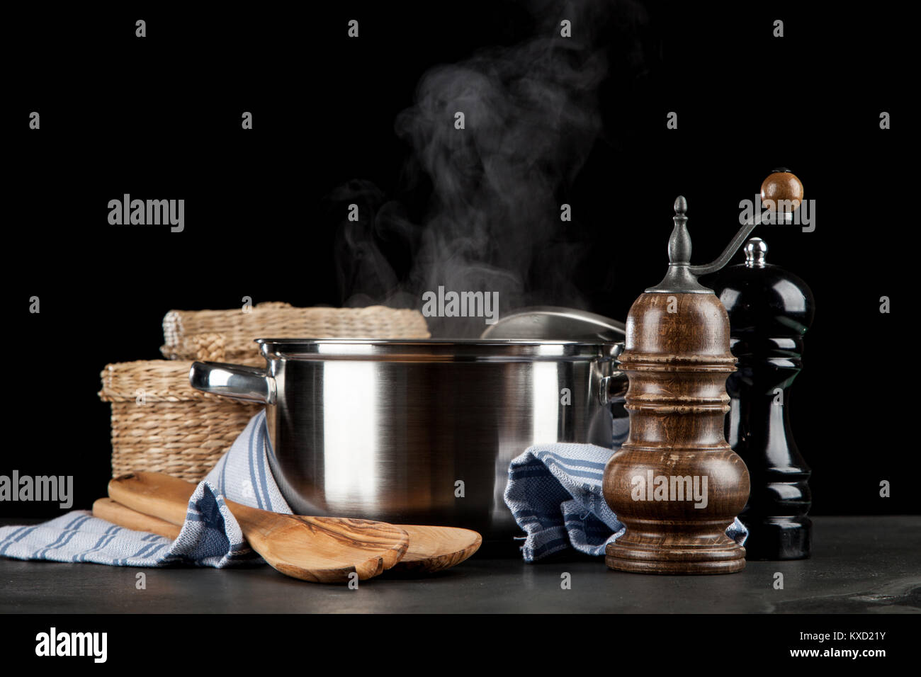 Steaming pot on black background Stock Photo - Alamy