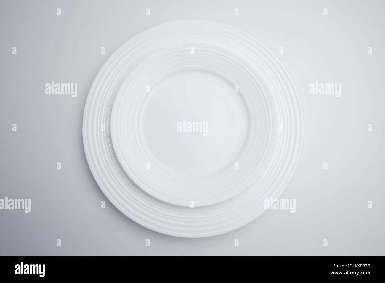 Overhead view of plates over white background Stock Photo - Alamy