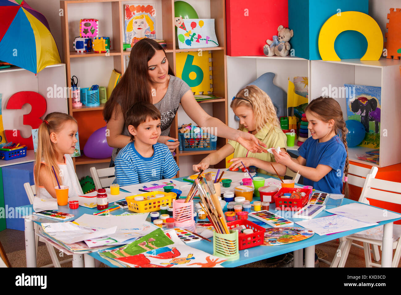 Children painting and drawing together. Craft lesson in primary school ...