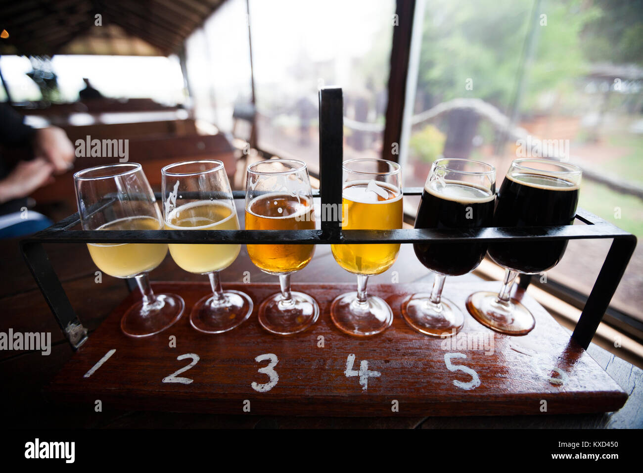 Close-up of craft beer in rack on table in restaurant Stock Photo - Alamy