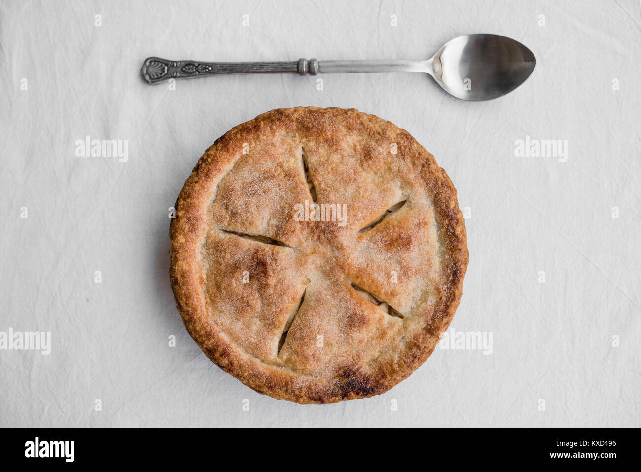 Overhead view of apple pie by spoon on table Stock Photo - Alamy