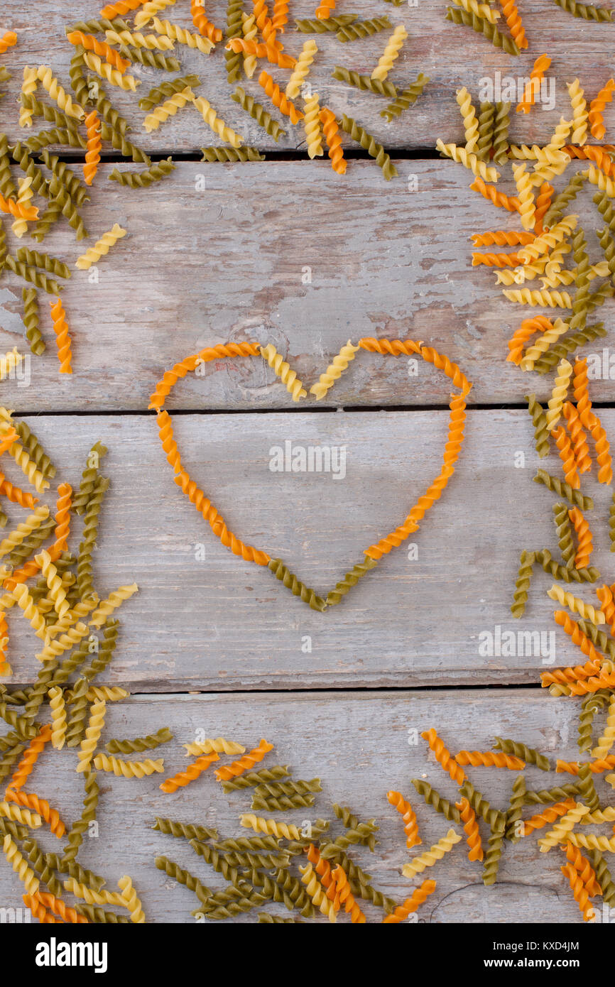 Frame from pasta, wooden background Stock Photo - Alamy