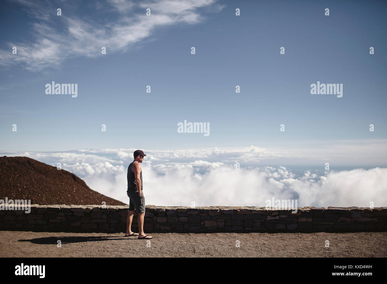 Side view of man standing by cloudy sky Stock Photo - Alamy