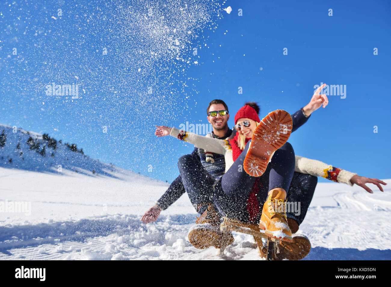 romantic winter scene, happy young couple having fun on fresh show on ...