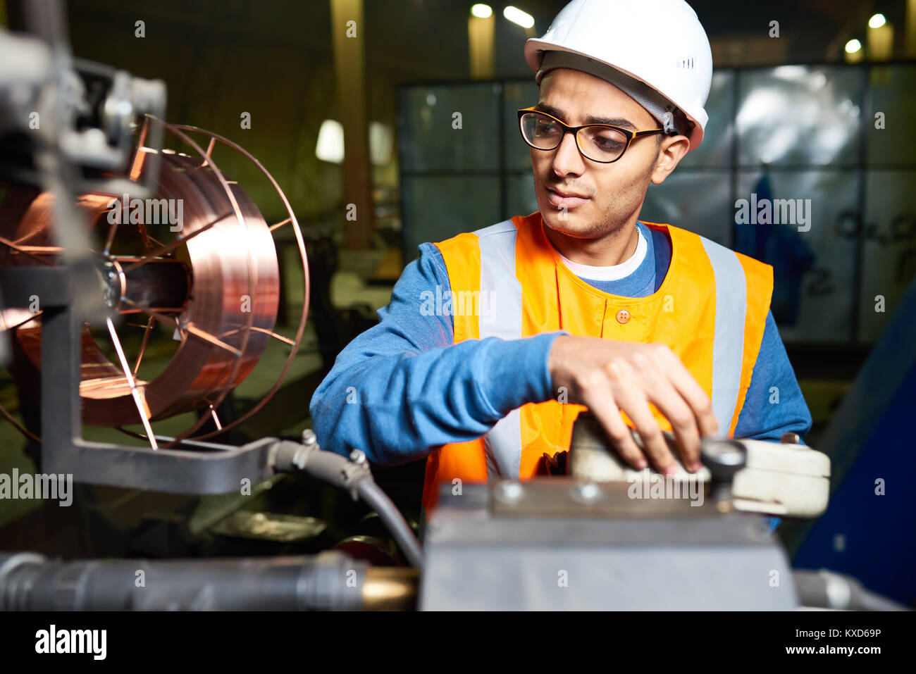 Machine Operator Wrapped up in Work Stock Photo - Alamy