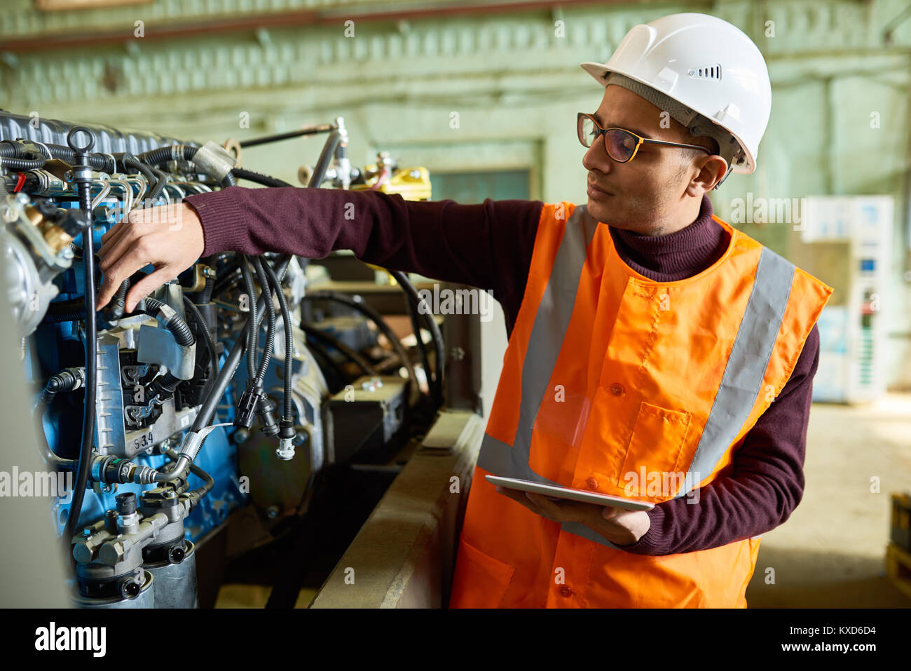 Handsome Technician Adjusting Engine Features Stock Photo - Alamy