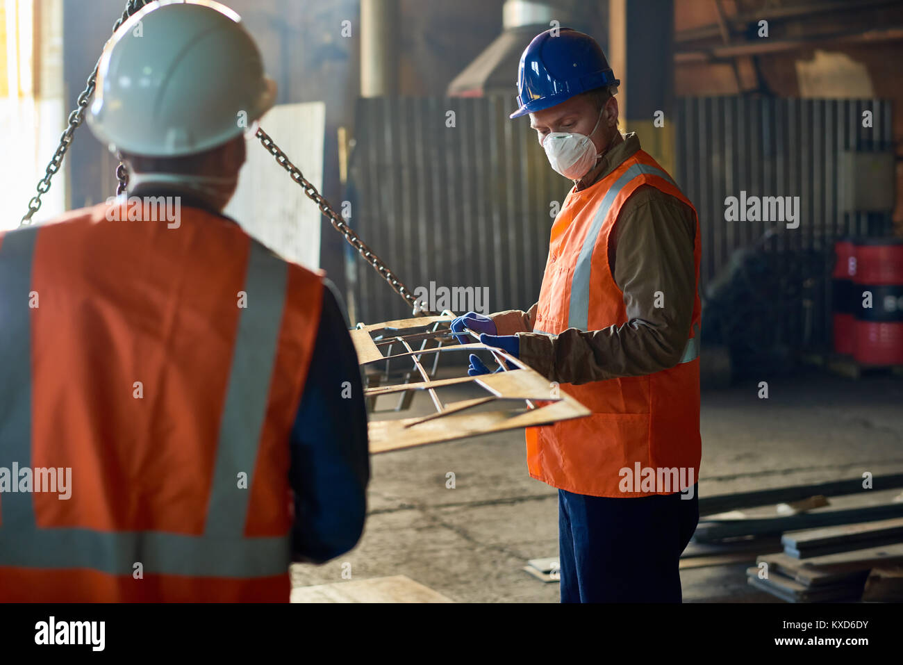 Factory Workers Using Lifting Beam Stock Photo - Alamy