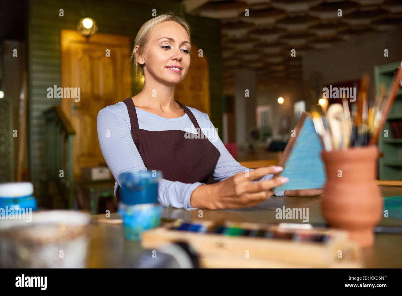 Smiling Artist Looking at Her Painting Stock Photo - Alamy
