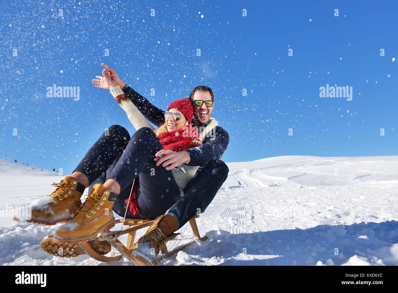 romantic winter scene, happy young couple having fun on fresh show on ...
