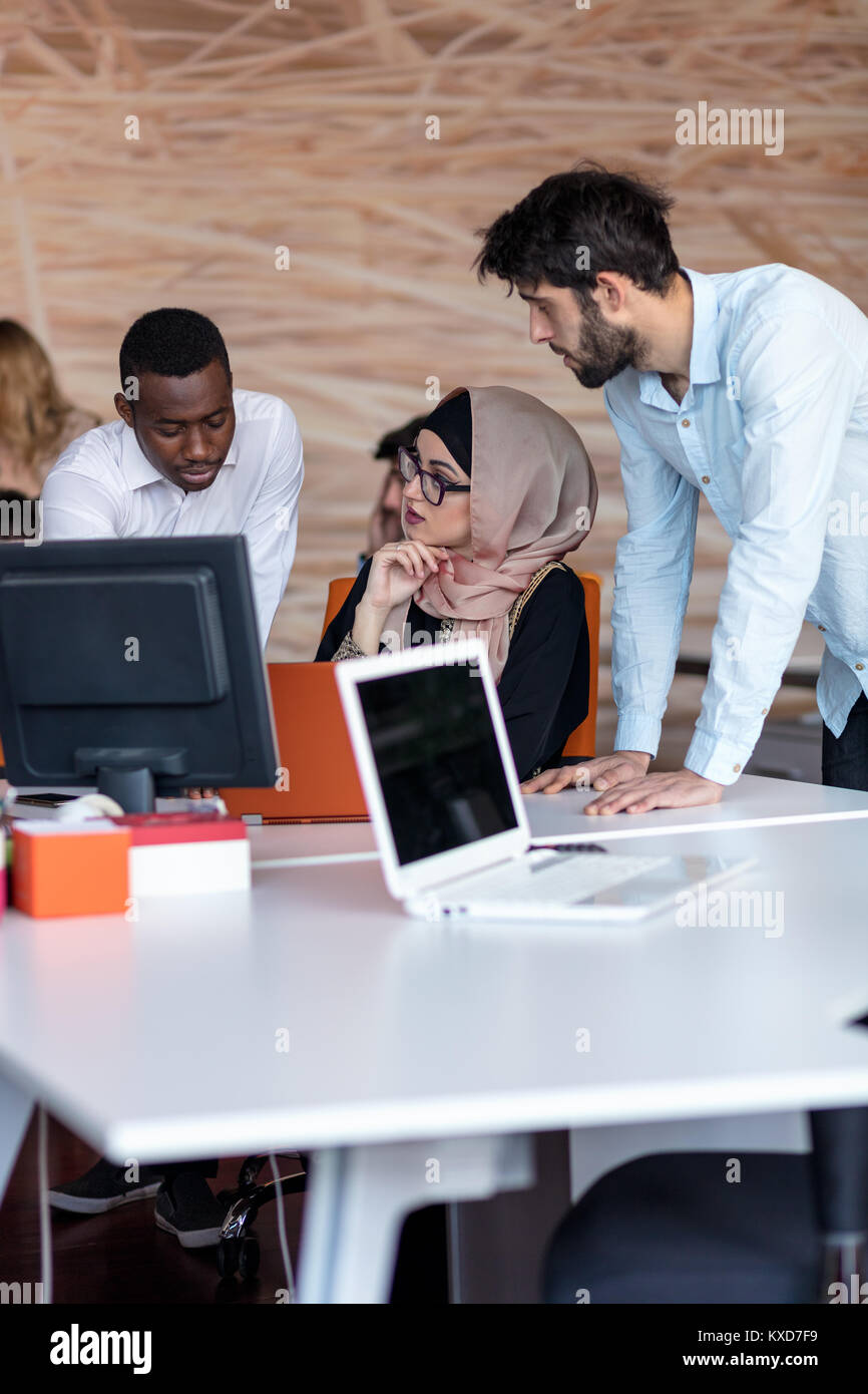 diverse college students using laptop and talking, learning exchanging ...