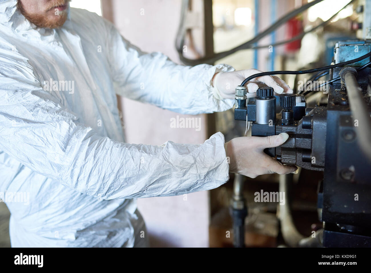 Worker Setting Up Machine on Biohazard Factory Stock Photo - Alamy