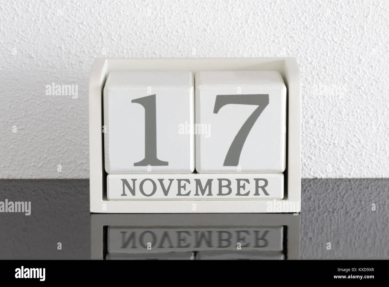 White block calendar present date 17 and month November on white wall ...