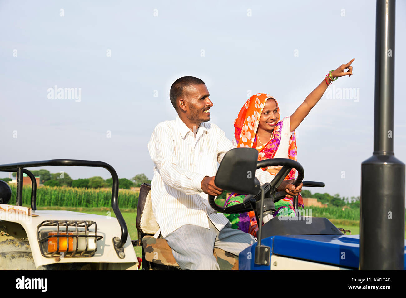 2 Indian Rural Farmer Couple Riding Tractor Farm Finger Pointing Stock ...